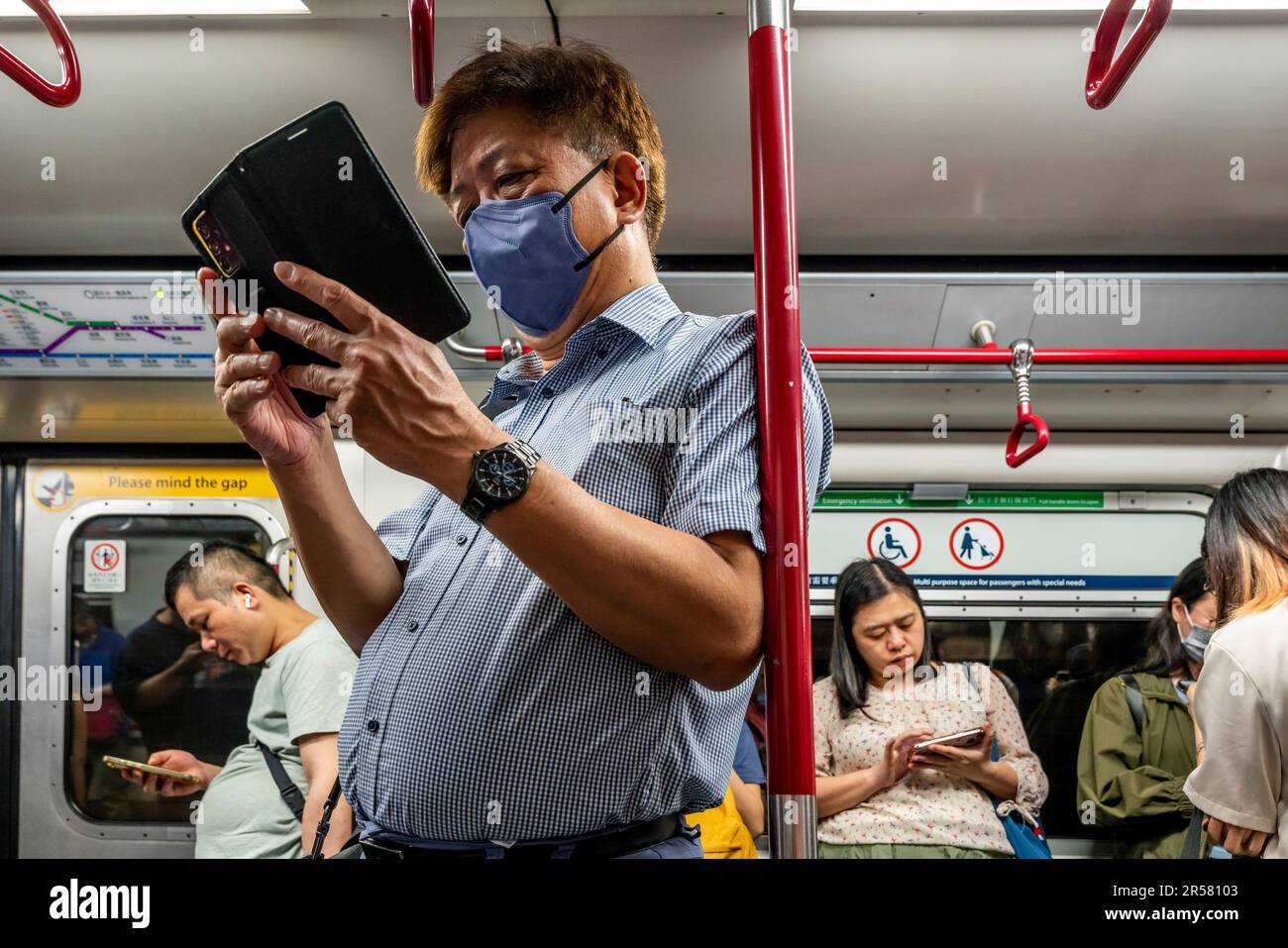 People Using Their Smartphones On A MTR Train, Hong Kong, China Stock ...