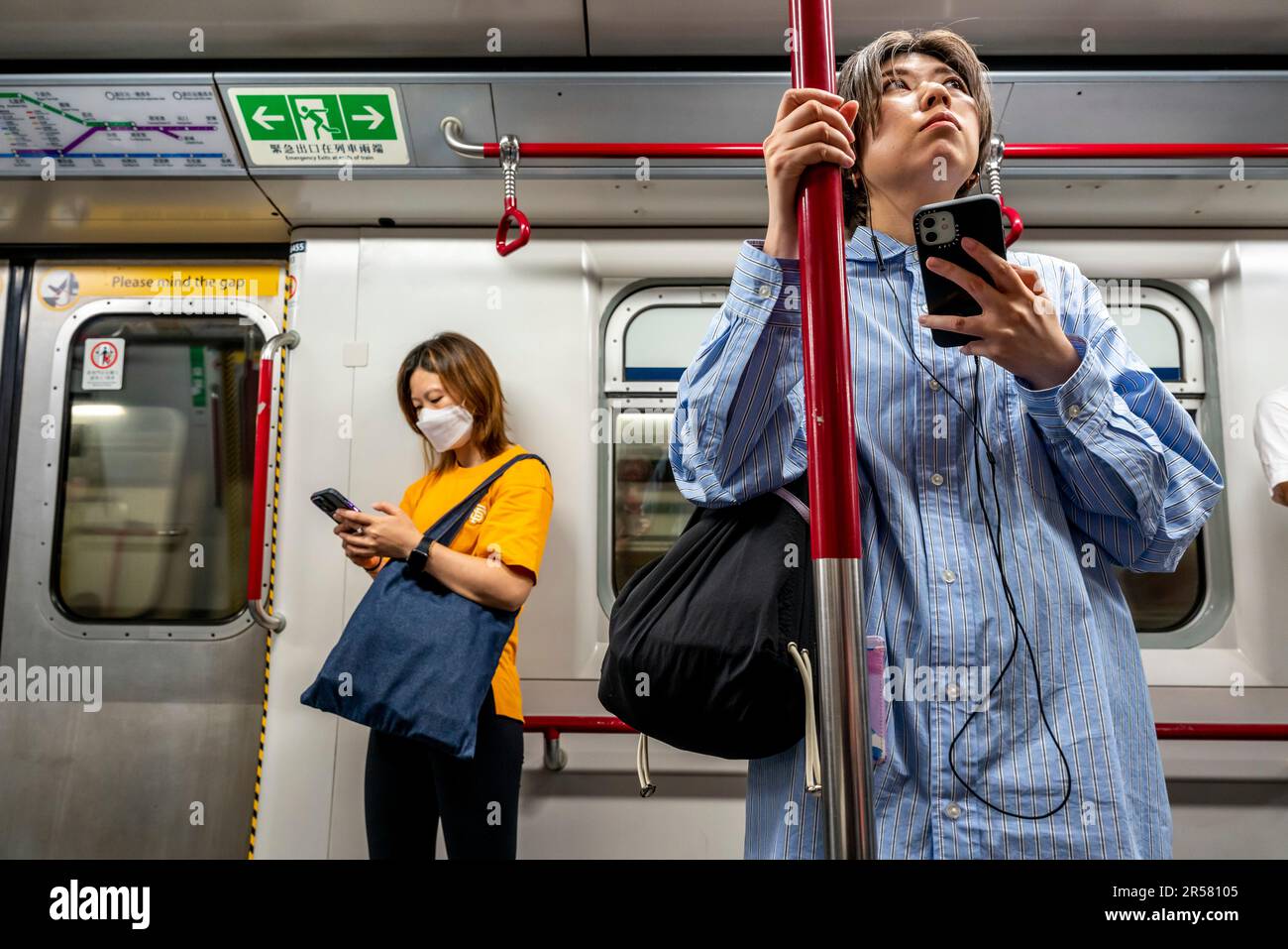 People Using Their Smartphones On A MTR Train, Hong Kong, China Stock ...