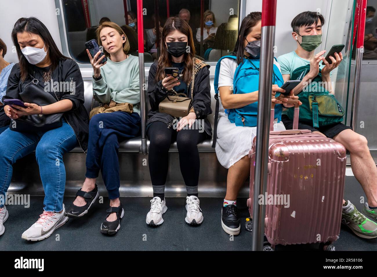 People Using Their Smartphones On A MTR Train, Hong Kong, China Stock ...