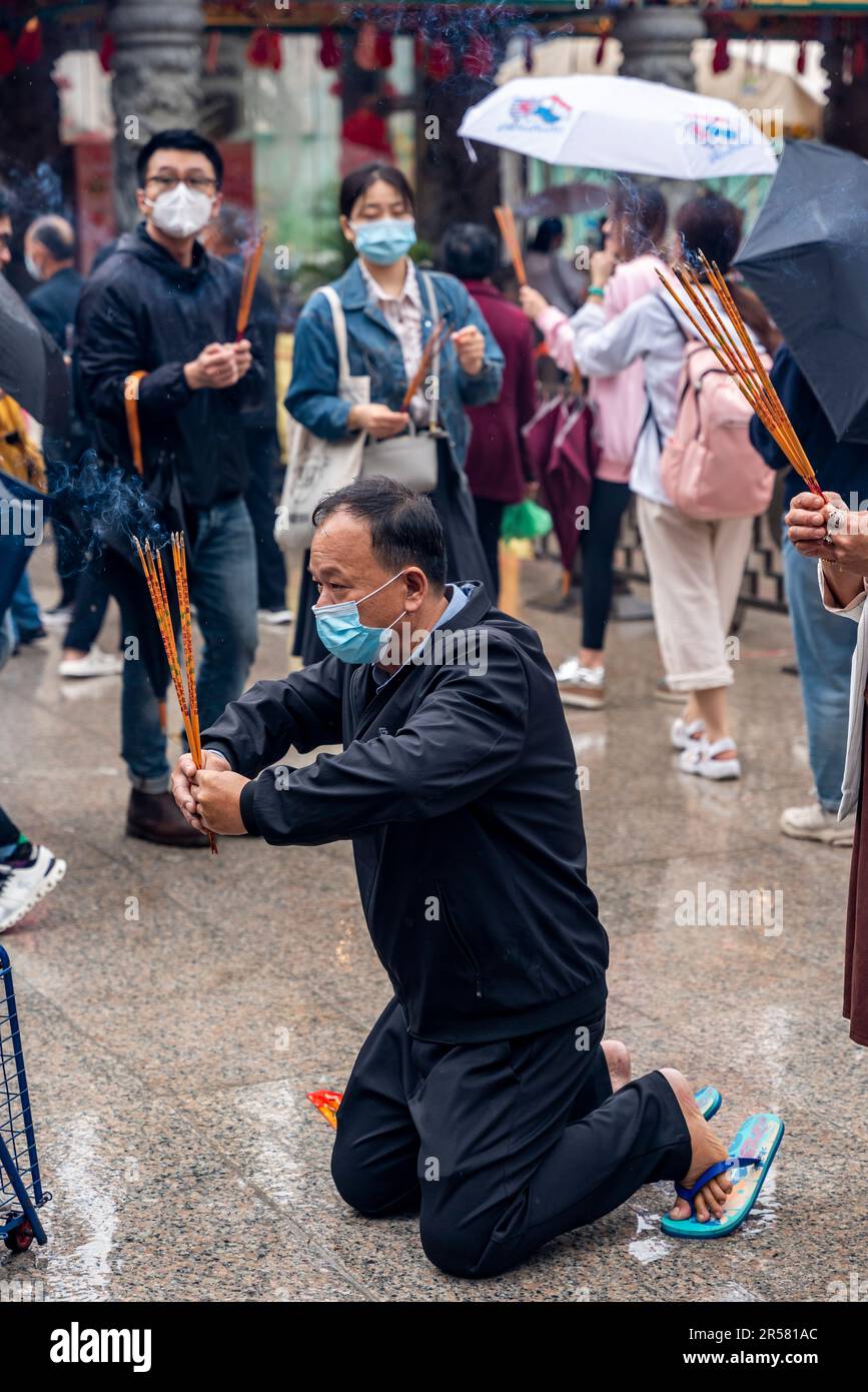 A Senior Chinese Man Worshipping At The Wong Tai Sin Temple, Hong Kong ...