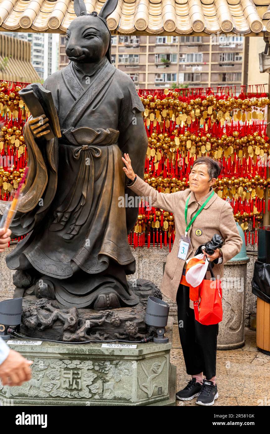 Chinese woman touching statue hi-res stock photography and images - Alamy