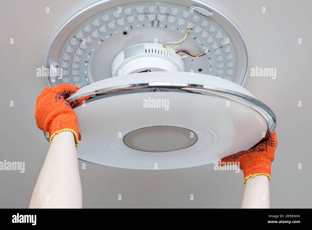 Electrician installs light on ceiling hi-res stock photography and ...