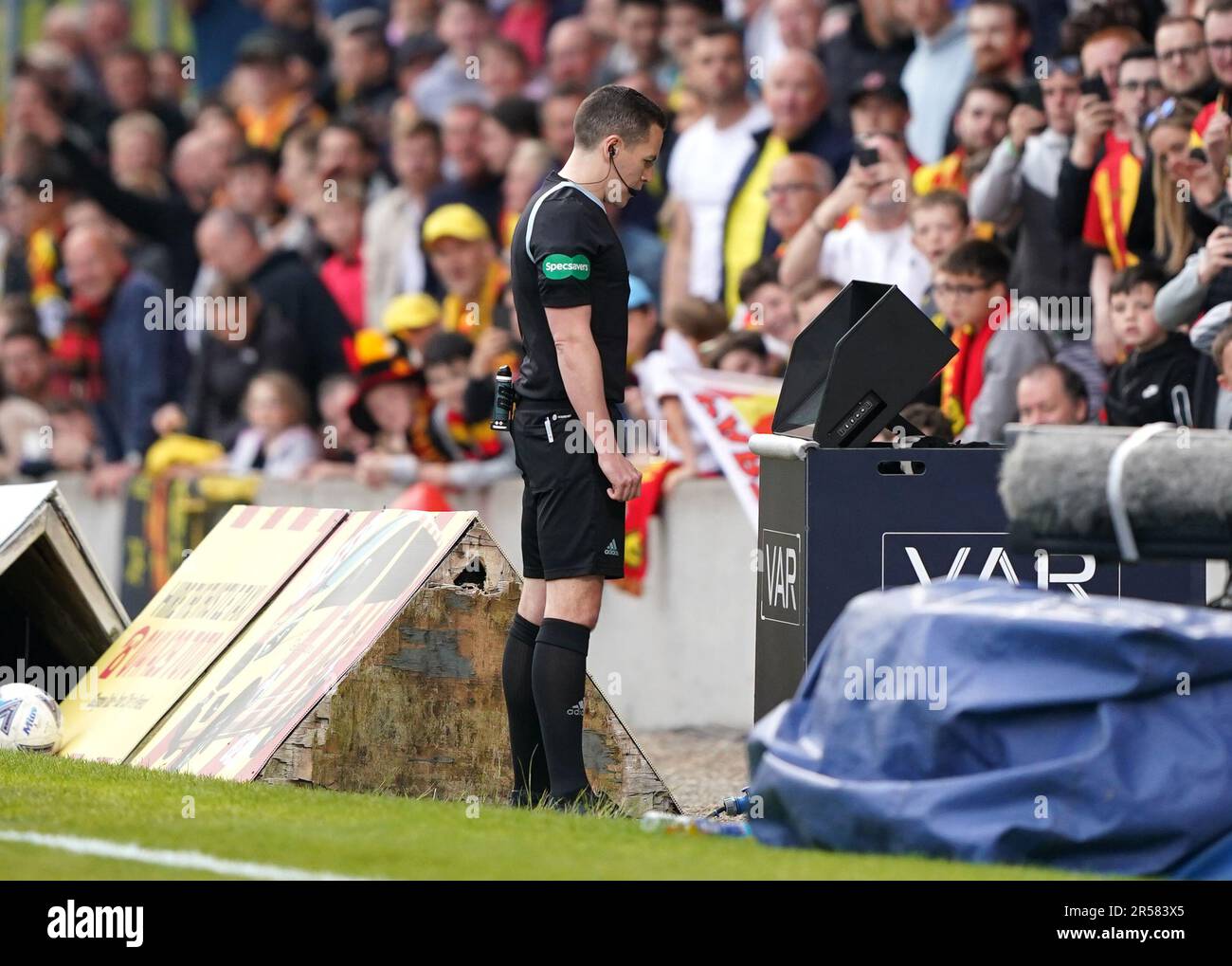 Referee David Munro checks the pitch side VAR screen during the cinch ...