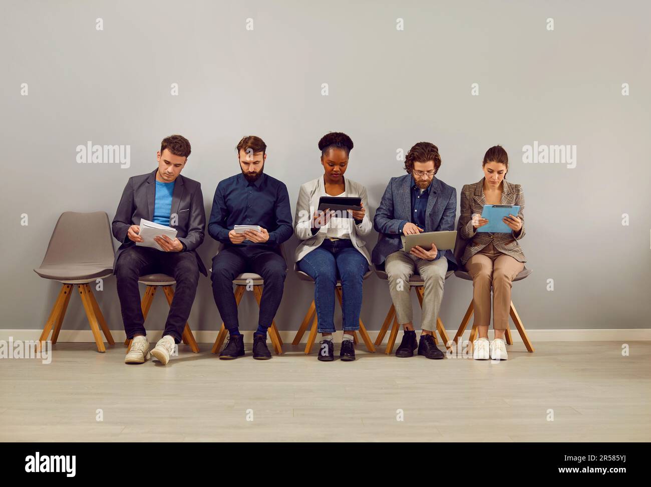 Group of people waiting for work meeting or job interview in line by ...