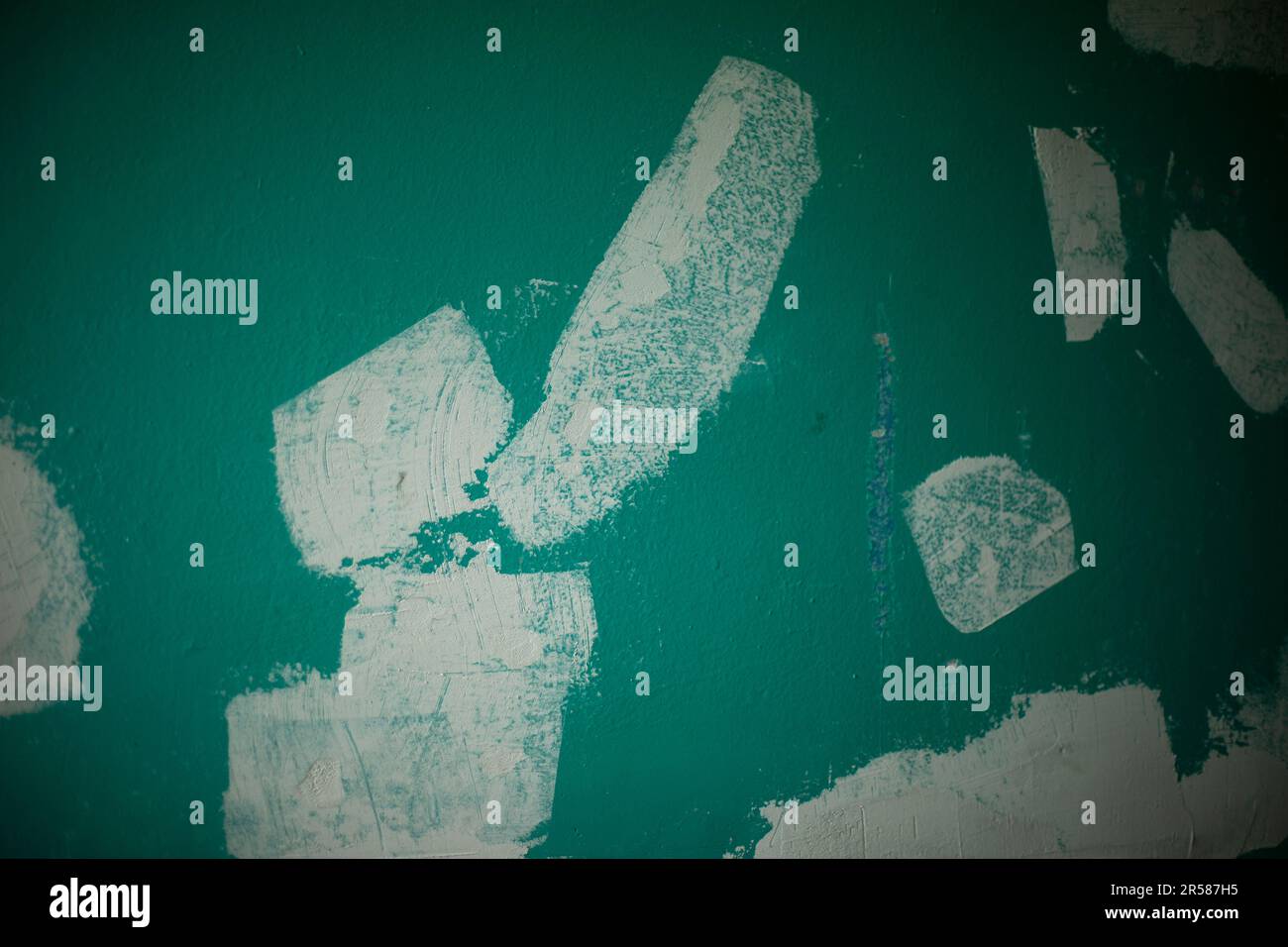 Repairing wall. White spots on green. Wall alignment. Paint application ...