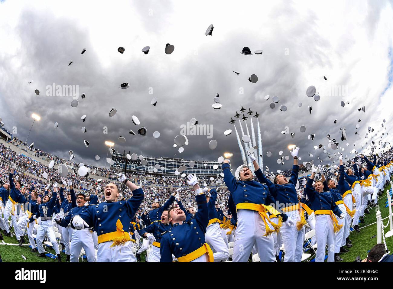Air Force Cadets toss their caps in the air as the Thunderbirds fly ...