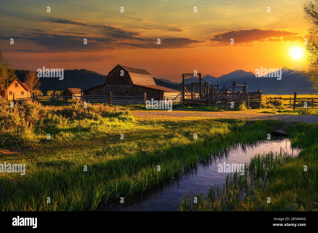 Colorful sunset over historic barn at Mormon Row in Grand Teton ...