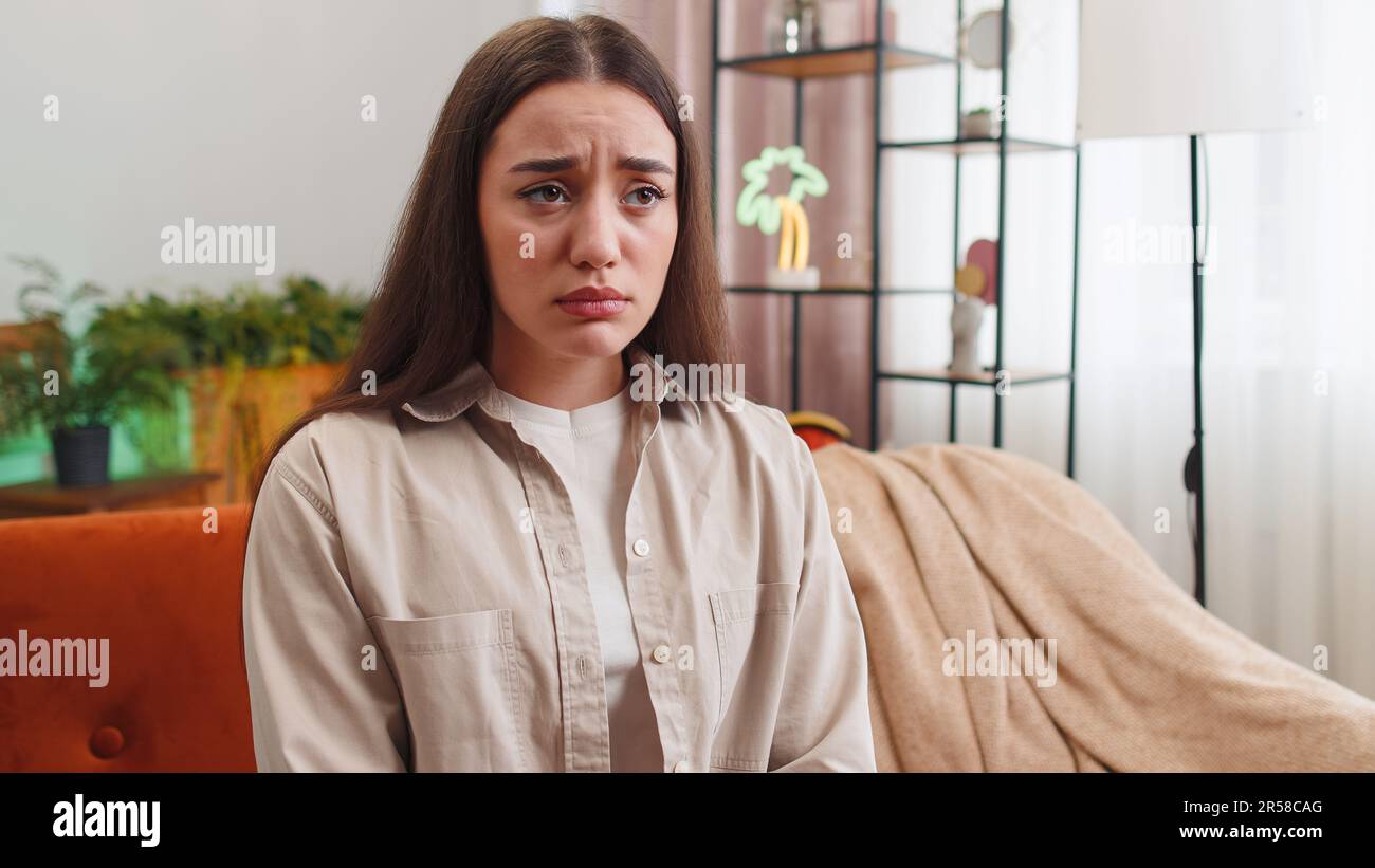 Upset disappointed young woman wipes tears and cries from despair ...