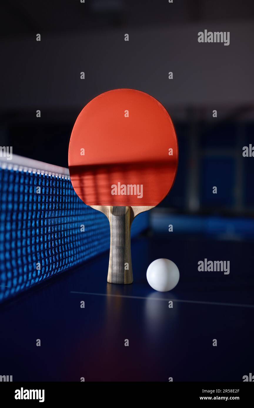 Table tennis equipment on blue ping pong table with grid net Stock ...
