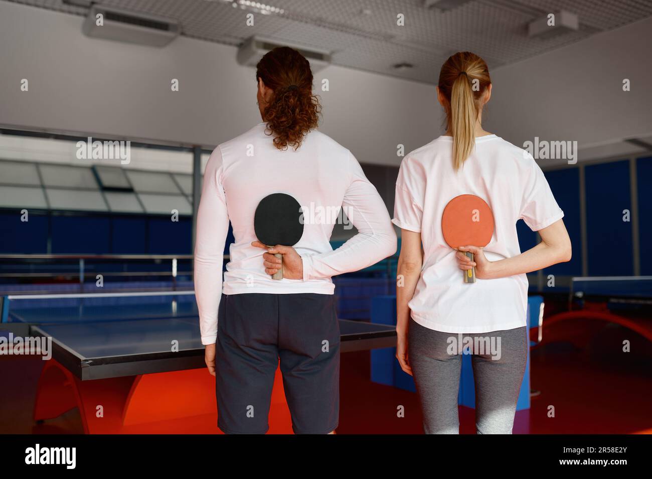 Male and female table tennis player holding racket behind back Stock ...