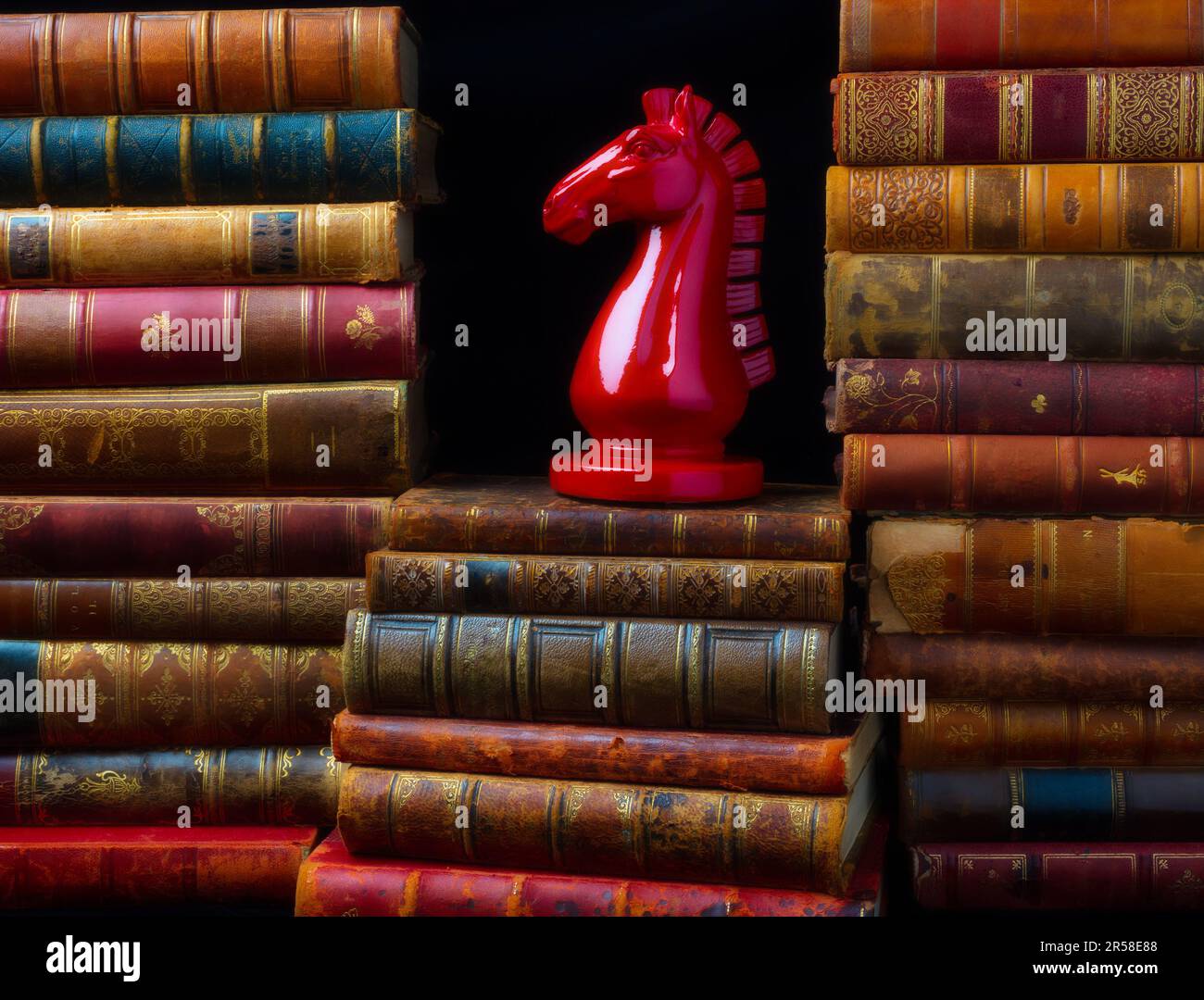 Old Books And Red Knight Still Life Stock Photo - Alamy