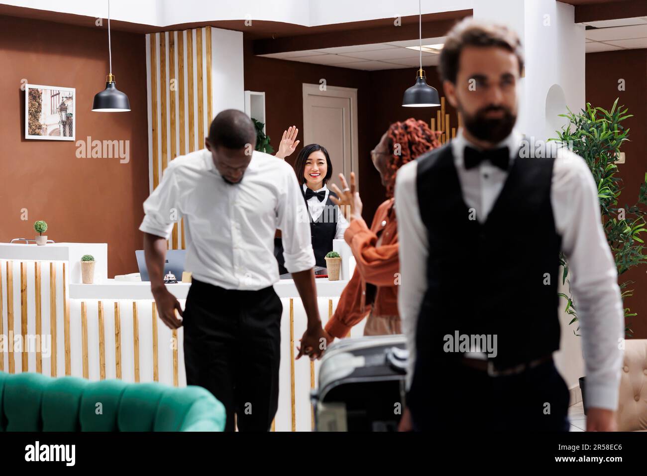 Asian woman waving at people after checking out of the hotel, wishing ...