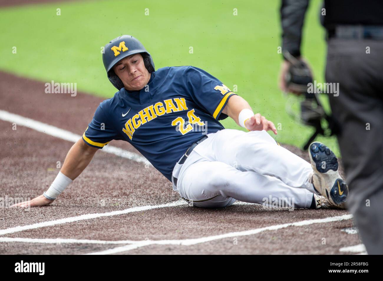 Michigan Wolverines outfielder Joey Velazquez (24) slides safely across ...