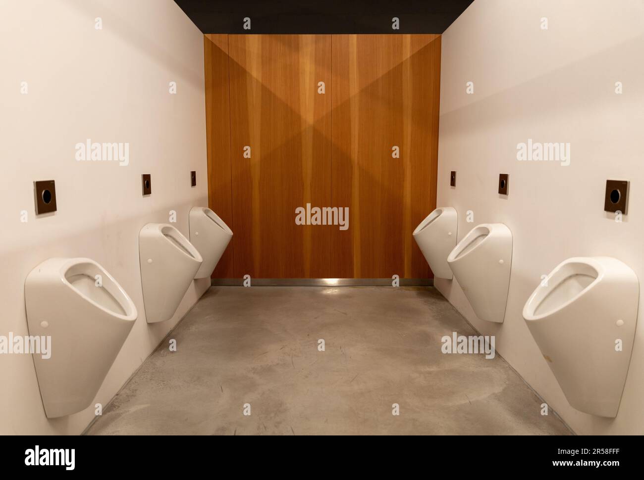 Public male toilet a line of urinals Stock Photo - Alamy