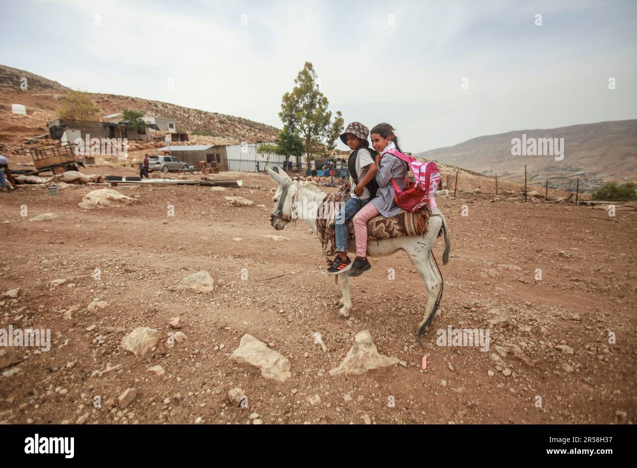 Children riding a donkey to school hi-res stock photography and images ...
