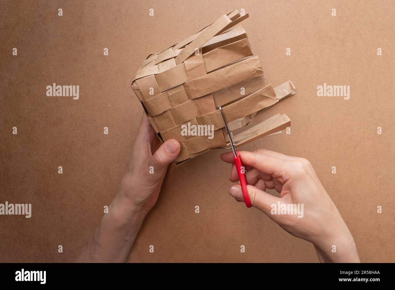 hands with scissors cutting tails of paper strips paper basket, do it ...