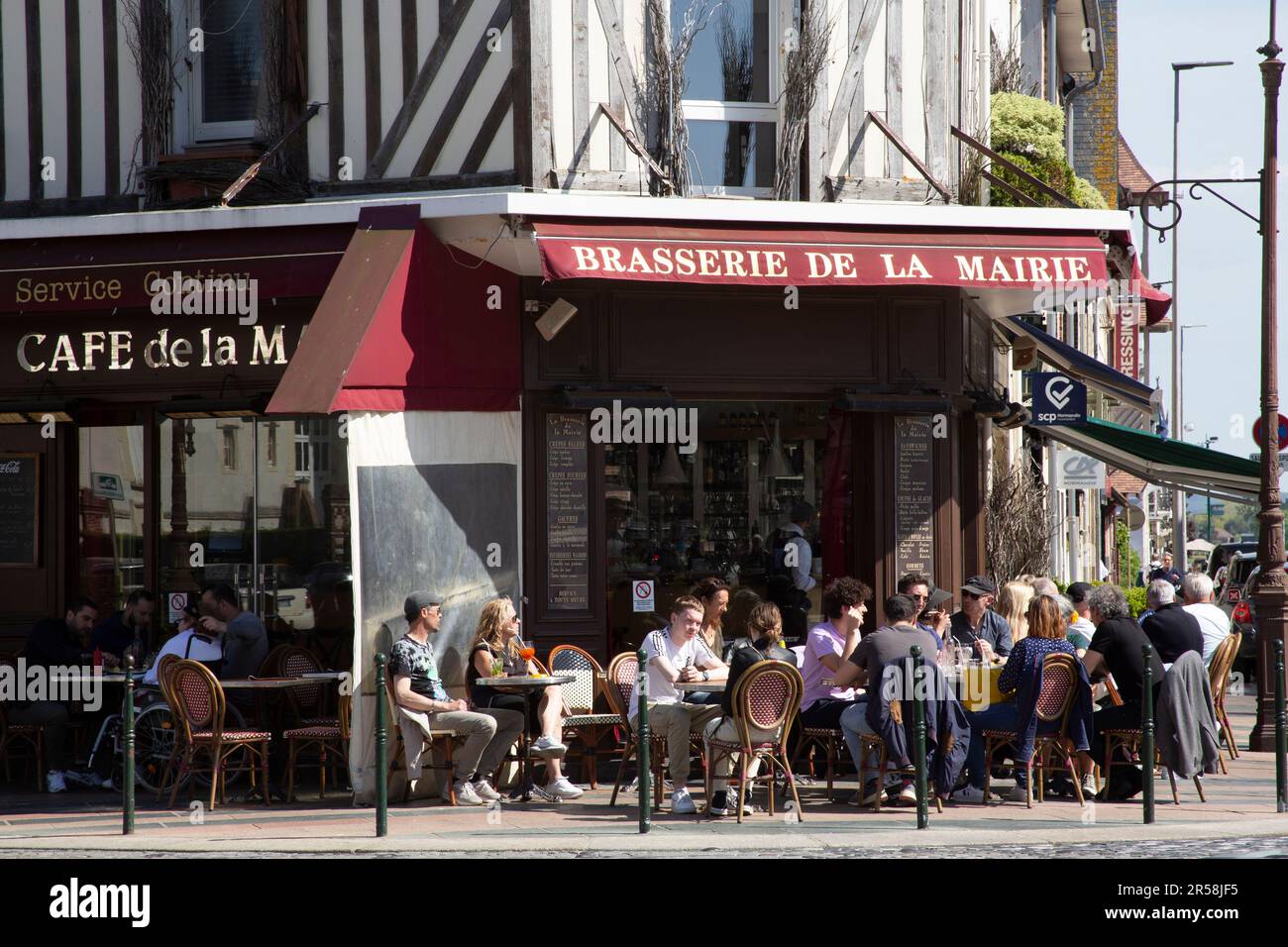 Corner cafe in the centre of Deauville with Normandy style architecture ...