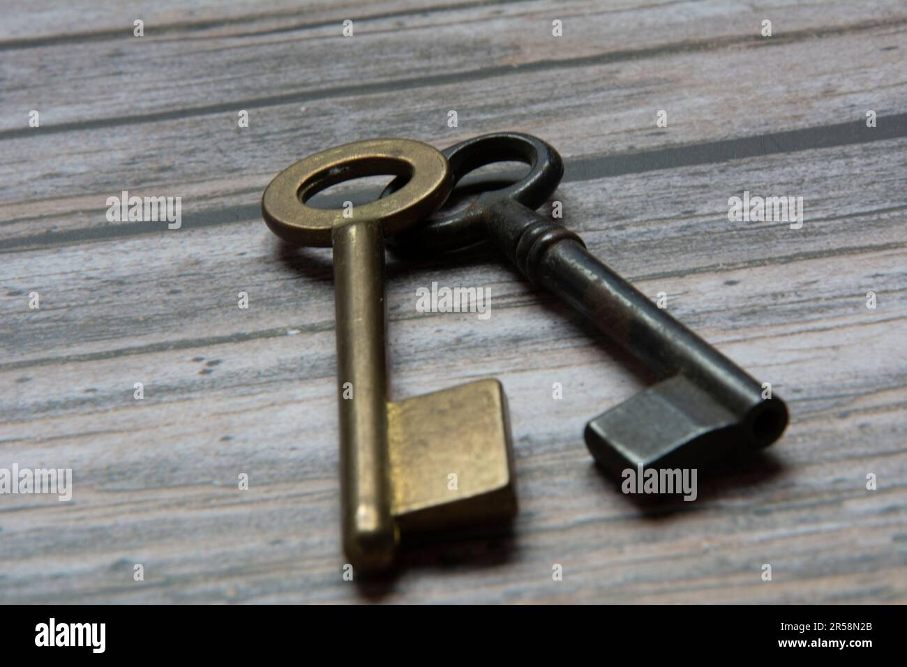 Old keys on iron and bronze, in a studio table. Wooden background Stock ...