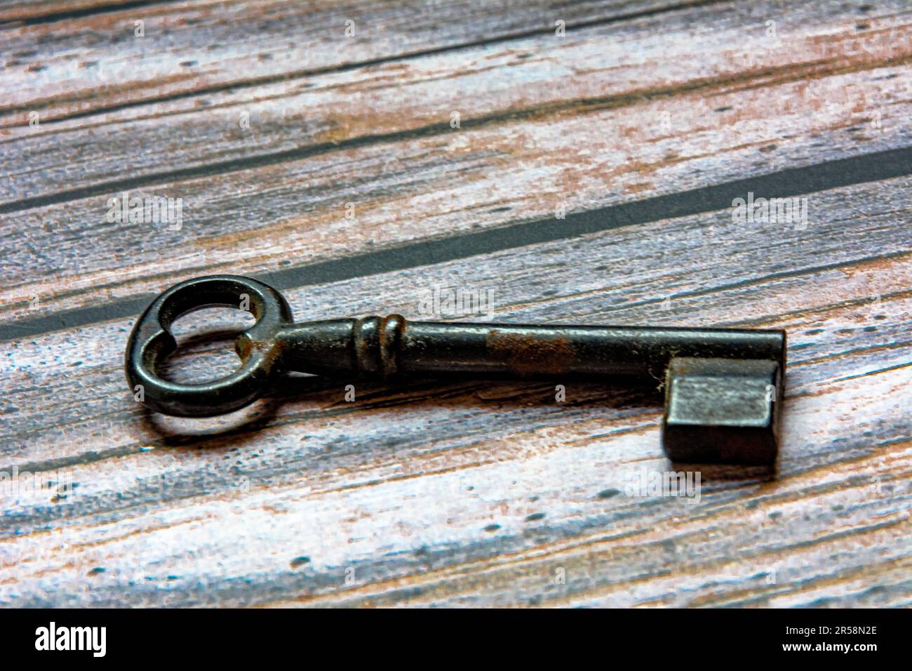 Old iron key photographed in a wooden background Stock Photo - Alamy