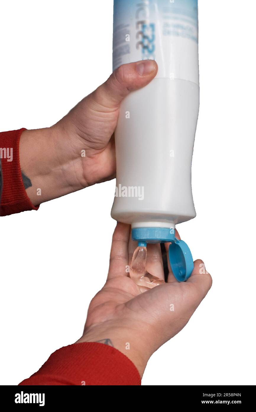 The hands of a professional barber squeeze shampoo into his hand before ...