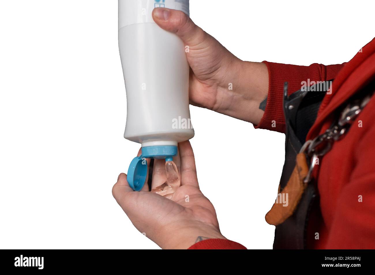 The hands of a professional barber squeeze shampoo into his hand before ...