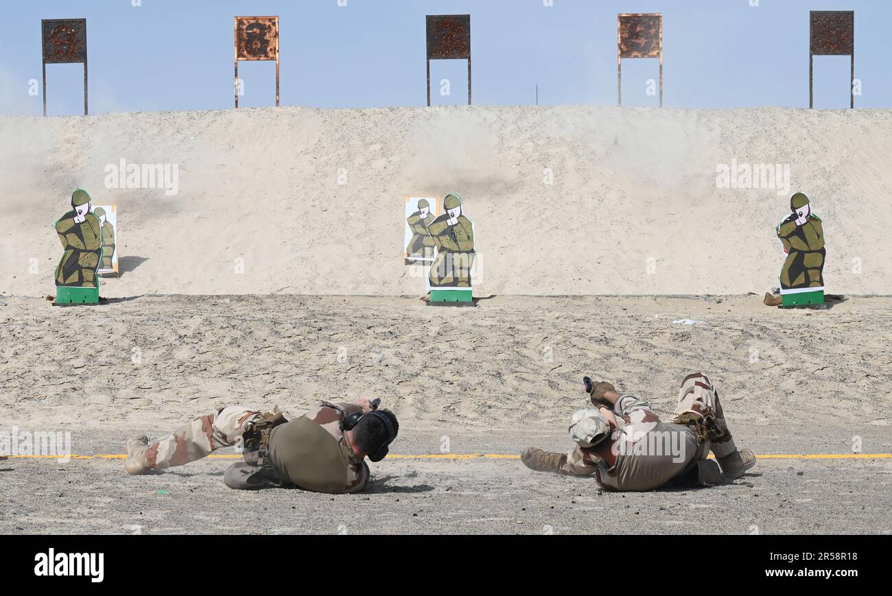 Two French Security Forces Members practice multiple firing positions ...