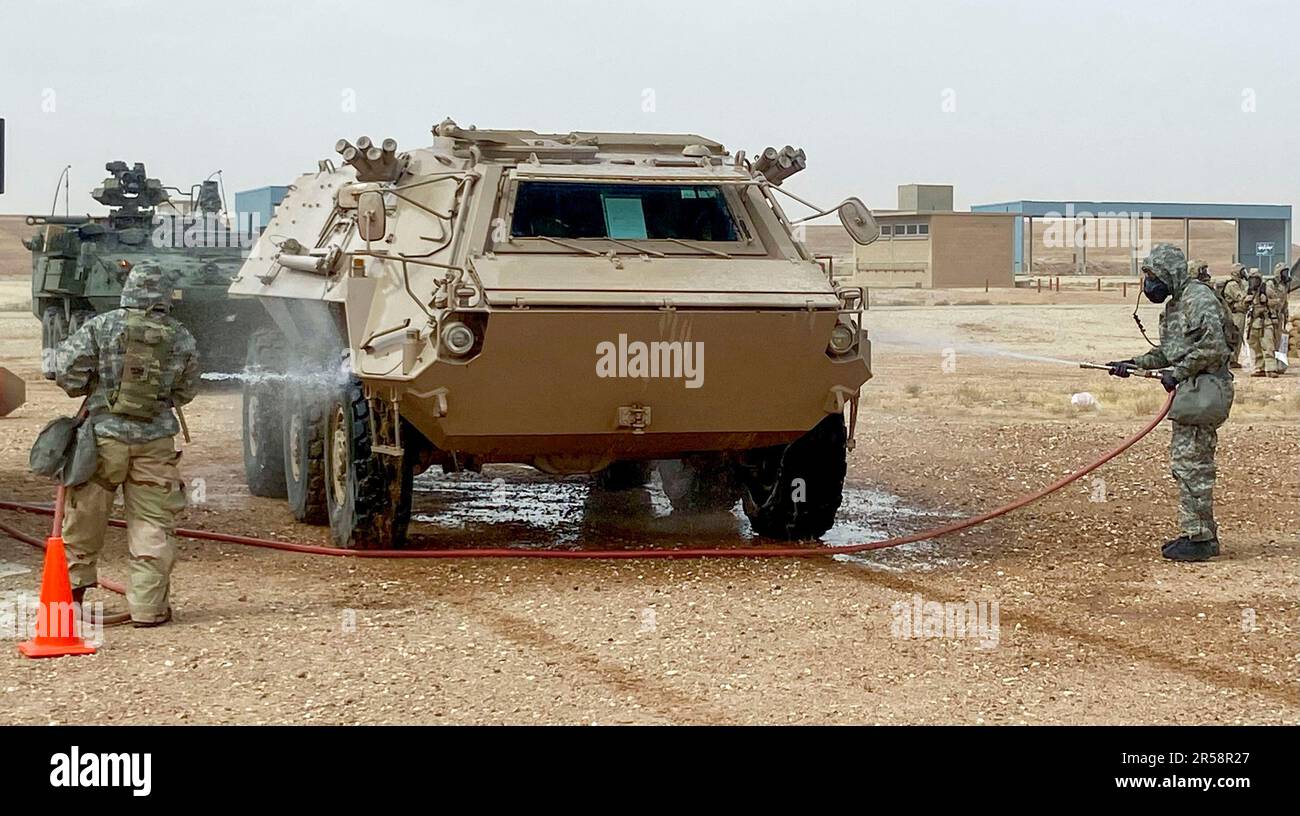 U.S. Army Soldiers practice the decontamination process by simulating ...