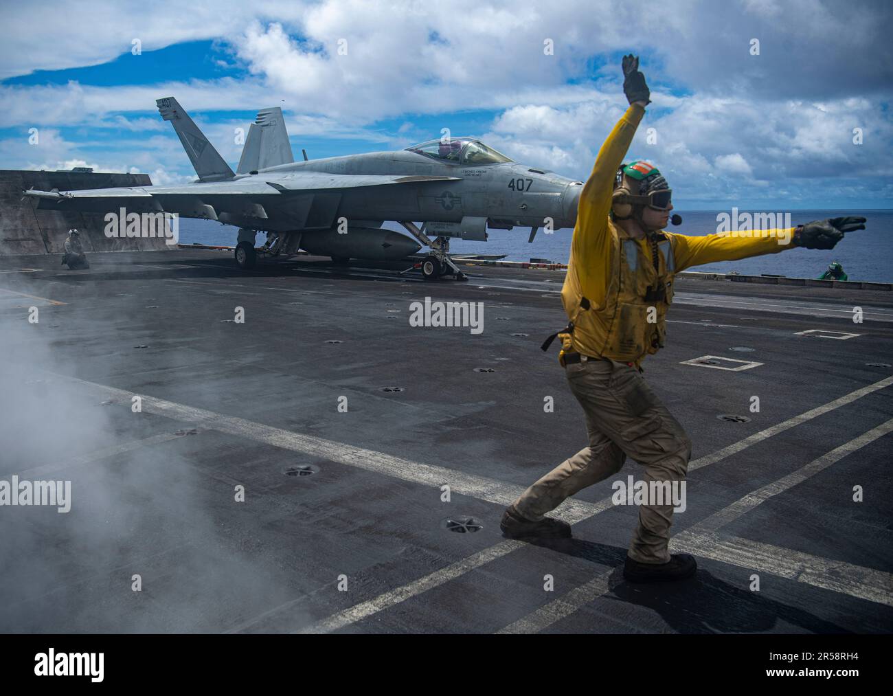 230601-N-DU622-1035 PACIFIC OCEAN (June 1, 2023) A U.S. Navy Sailor assists in flight operations ...