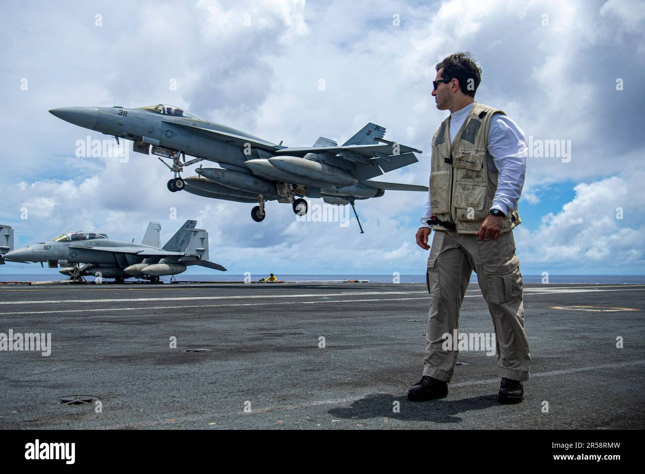 230601-N-DU622-1281 PACIFIC OCEAN (June 1, 2023) U.S. Navy Lt. Ben Sanabria, from Miami, watches ...