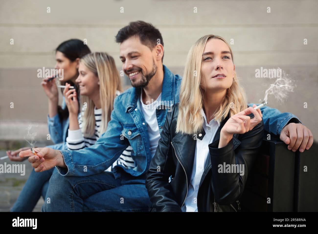 People smoking cigarettes at public place outdoors Stock Photo - Alamy