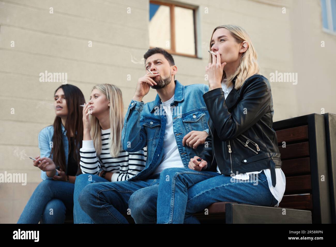 People smoking cigarettes at public place outdoors Stock Photo - Alamy