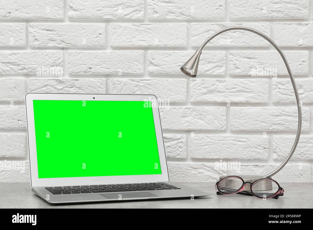 Laptop display with chroma key on desk in room. Comfortable workplace ...