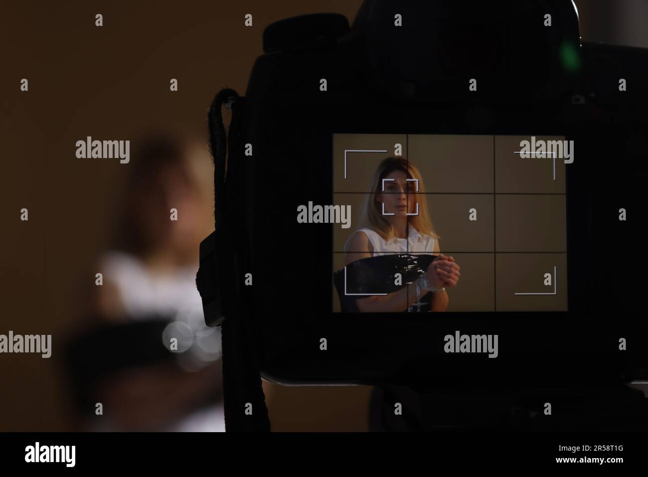 Woman taped up and taken hostage on dark background, view through ...