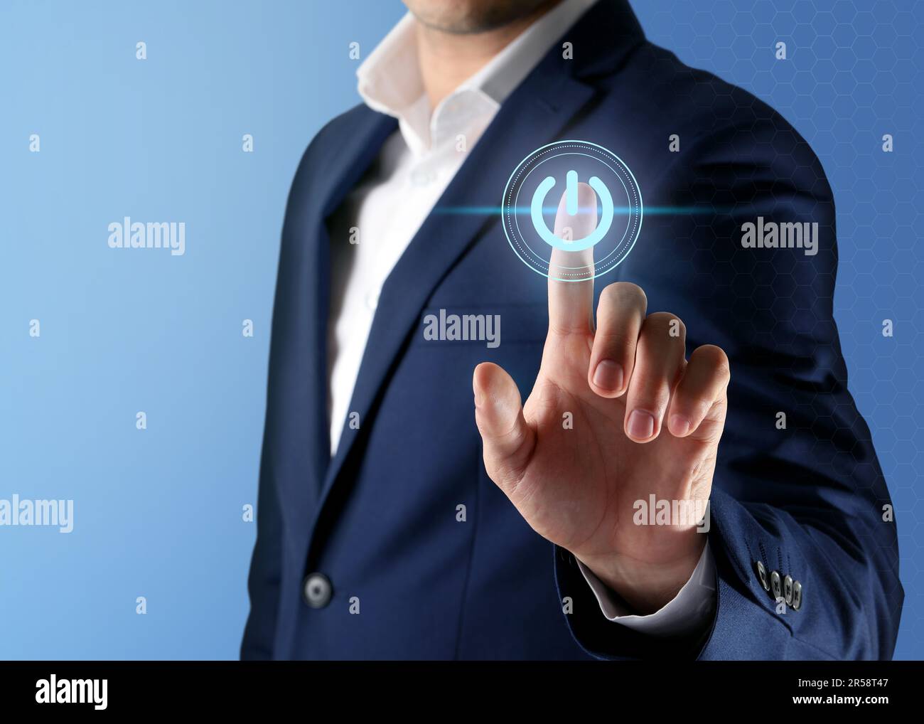 Man pressing start button on virtual screen against blue background ...
