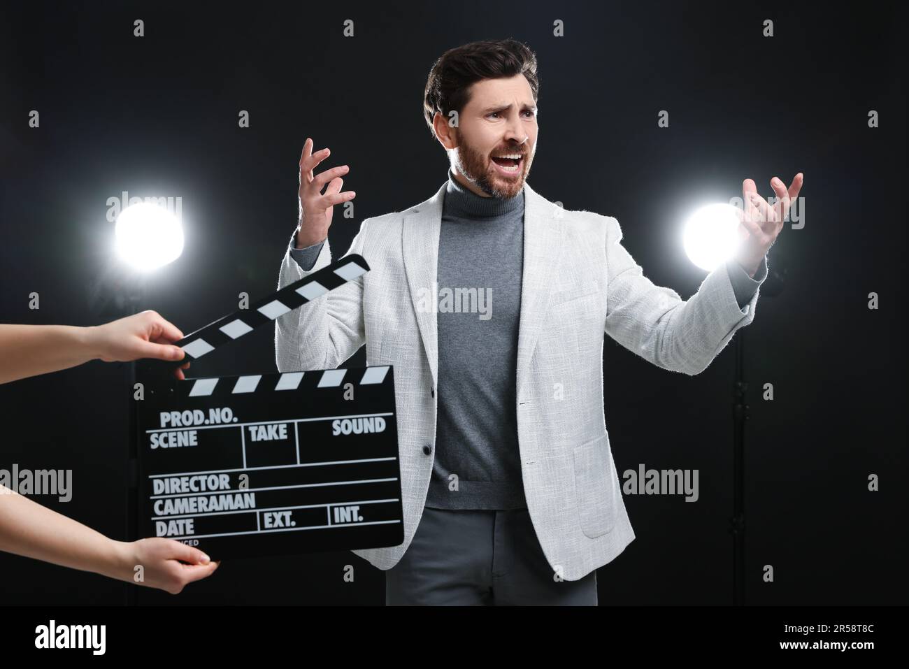 Emotional actor performing while second assistant camera holding ...