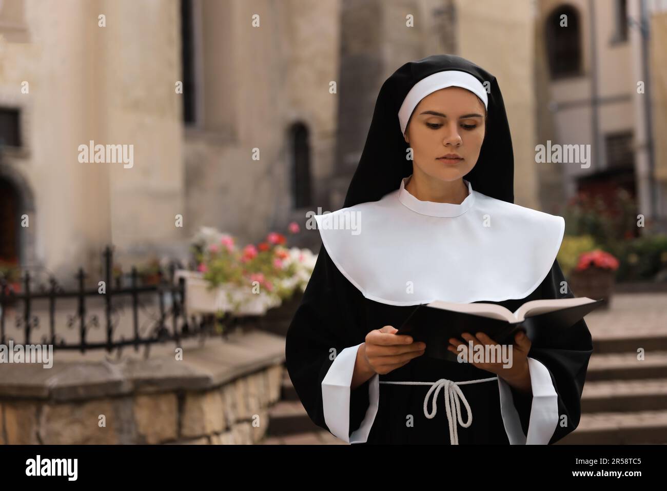 Young nun reading bible hi-res stock photography and images - Alamy