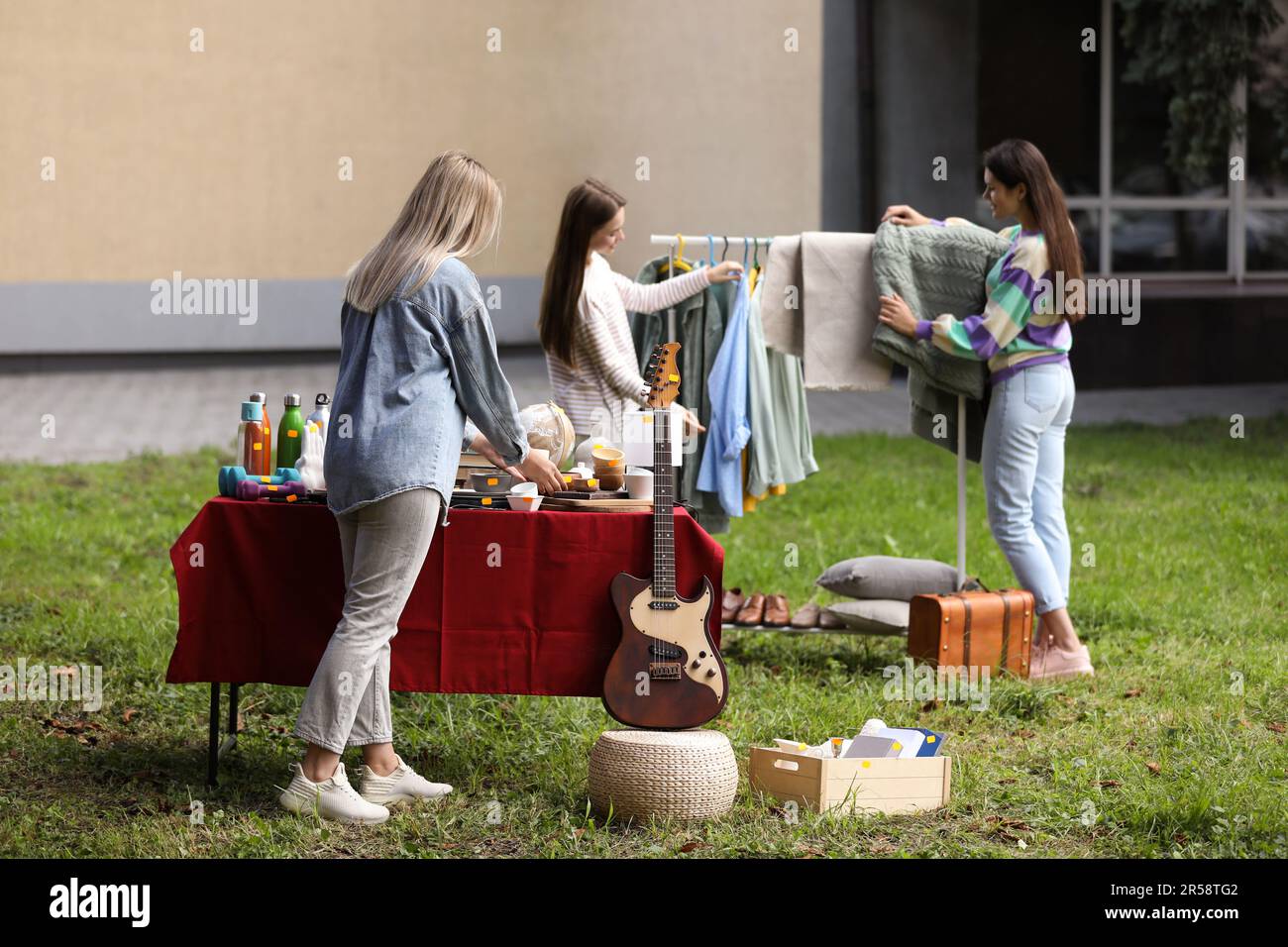 Women choosing items on garage sale in yard Stock Photo - Alamy