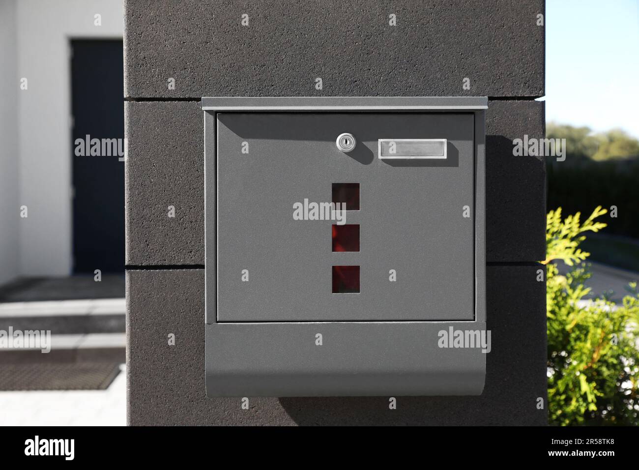 Black metal letter box on brick wall outdoors Stock Photo - Alamy