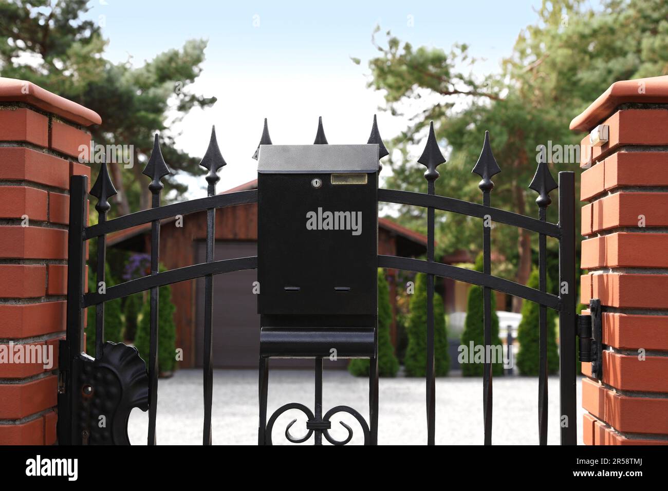 Black metal letter box on fence outdoors Stock Photo - Alamy