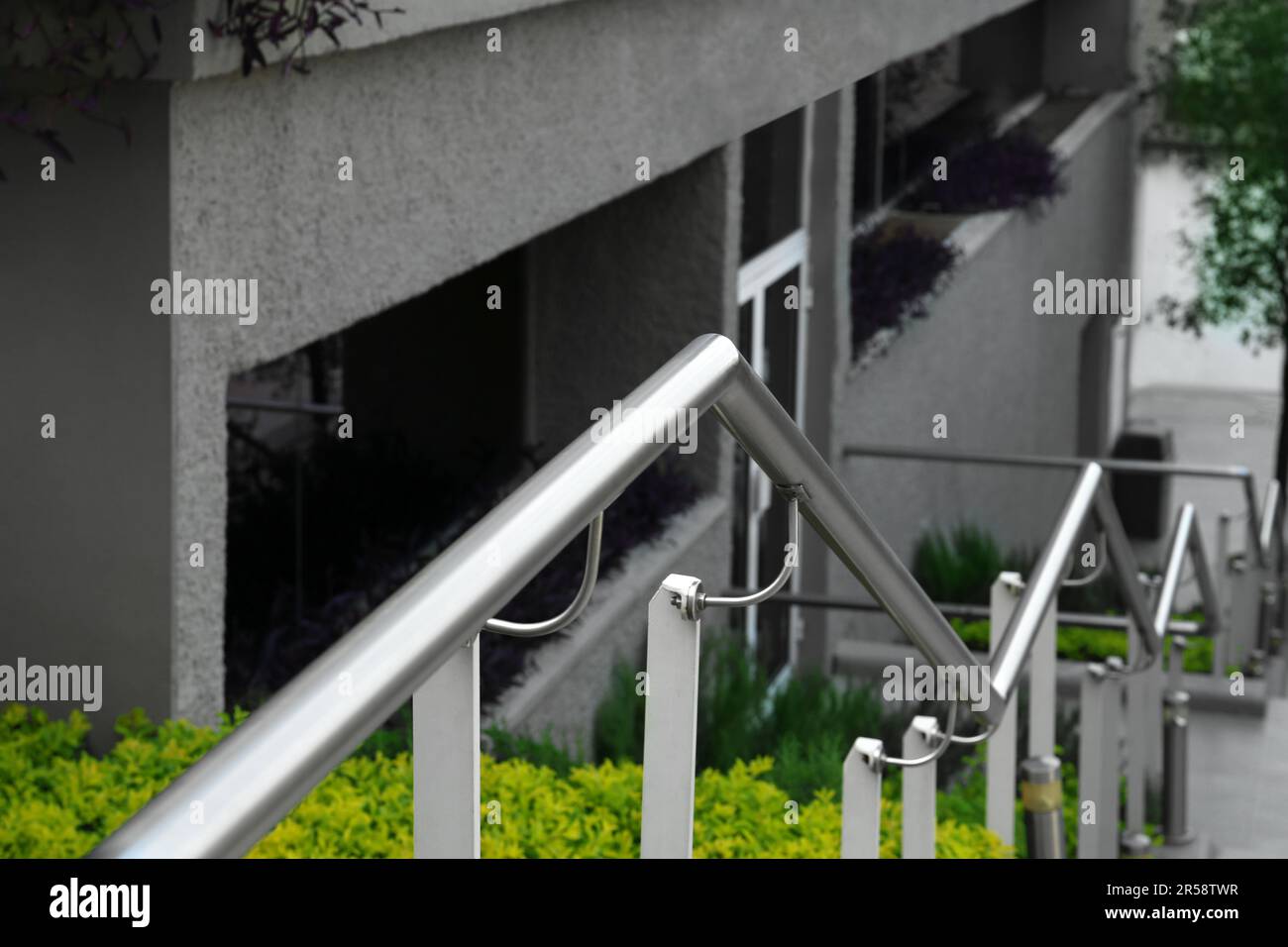 Outdoor staircase with metal handrails near beautiful plants, closeup ...