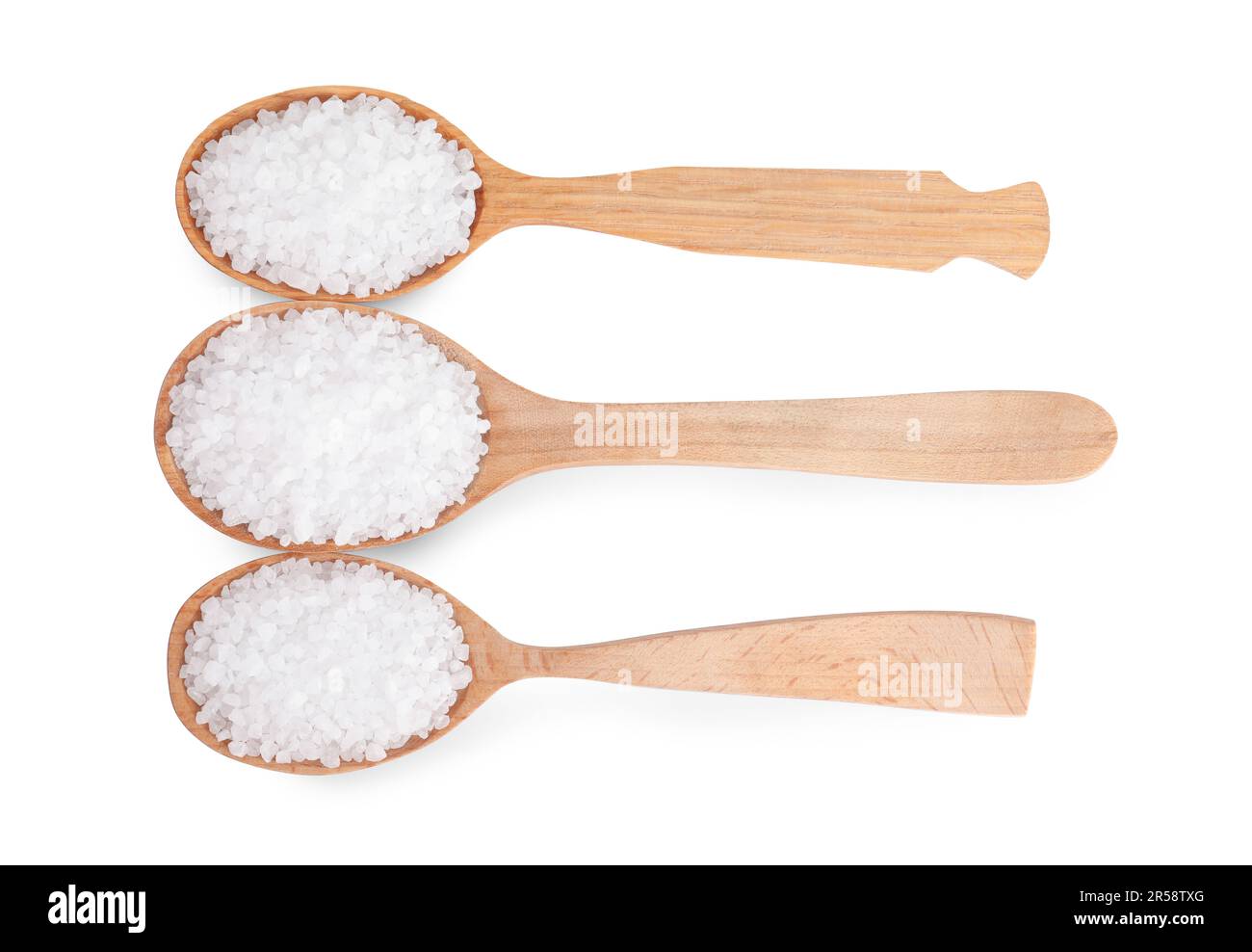 Wooden spoons with natural sea salt isolated on white, top view Stock ...