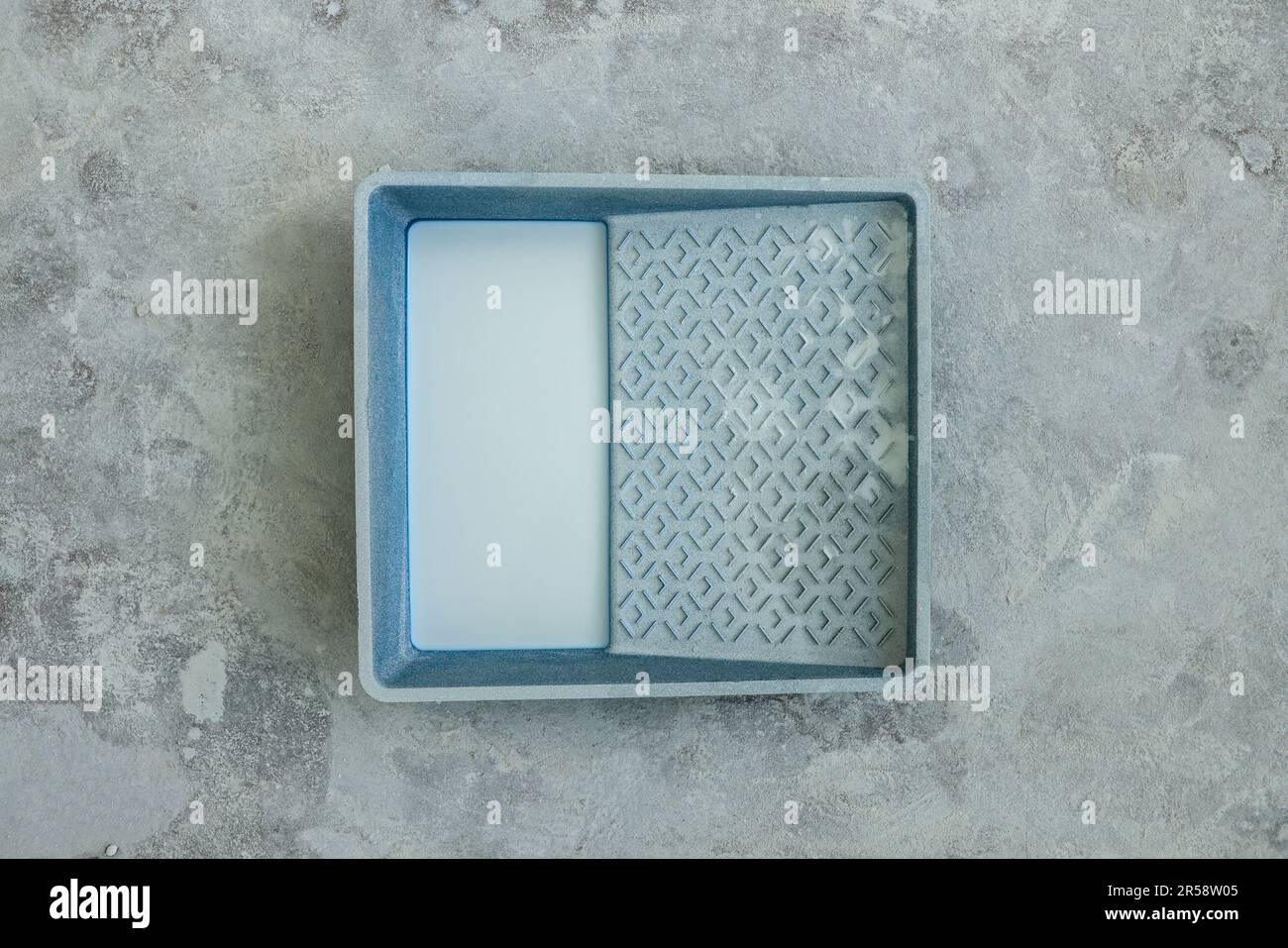 Container with white paint on floor, top view Stock Photo - Alamy