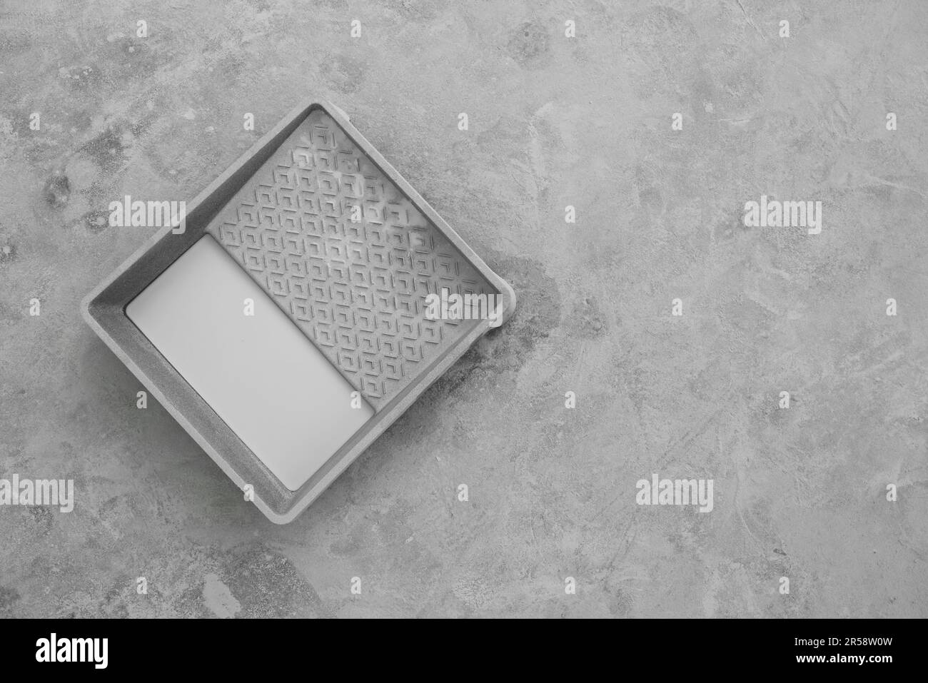 Container with white paint on floor, top view. Space for text Stock ...