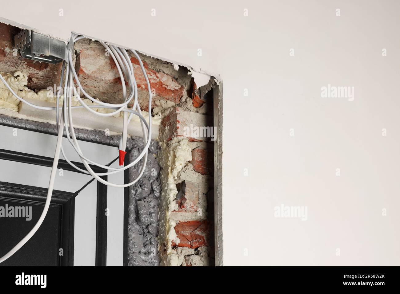 Cables in wall near doors indoors. Installation of electrical wiring ...