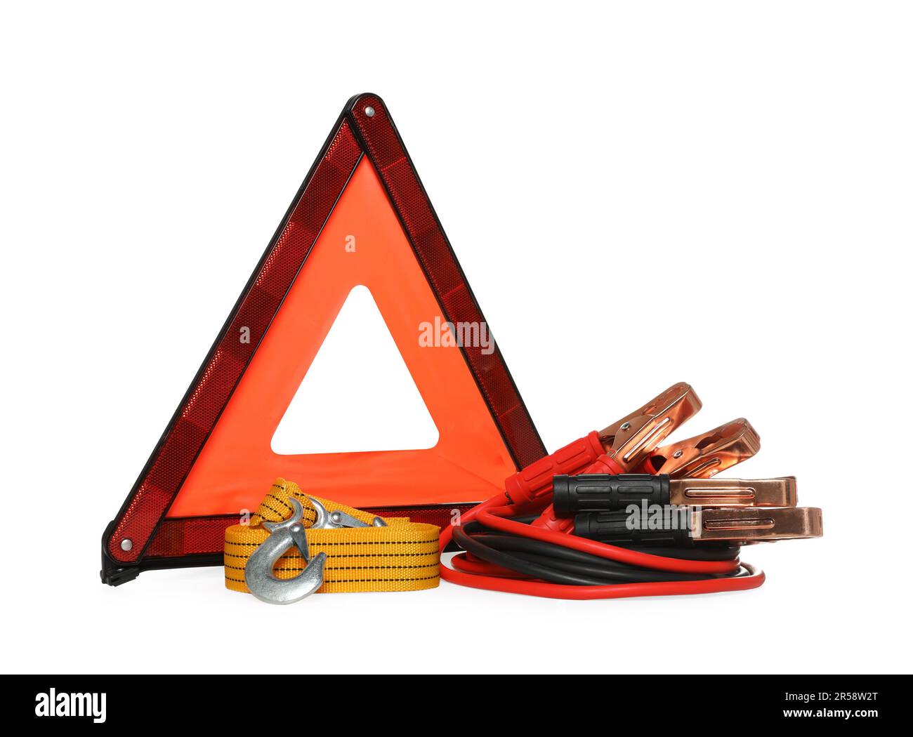 Emergency warning triangle, towing strap and battery jumper cables on ...
