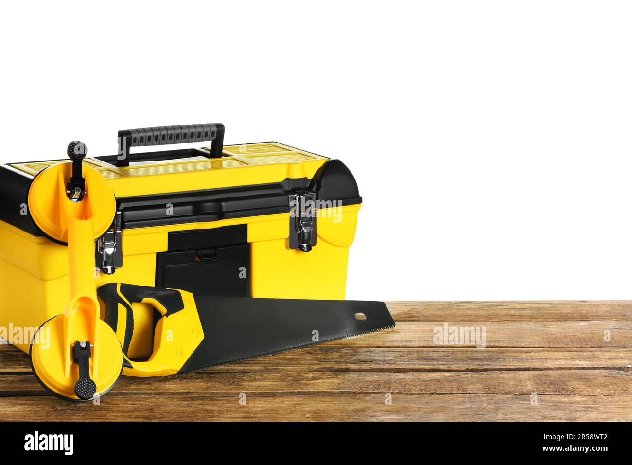 Plastic box with different tools on wooden table against white ...