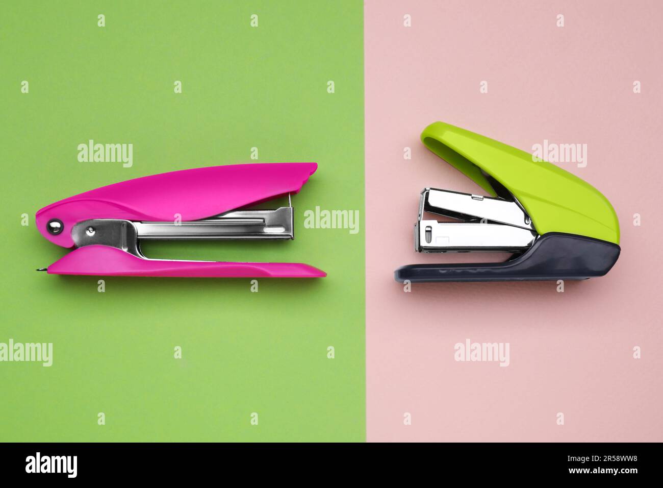 New bright staplers on color background, flat lay. School stationery ...