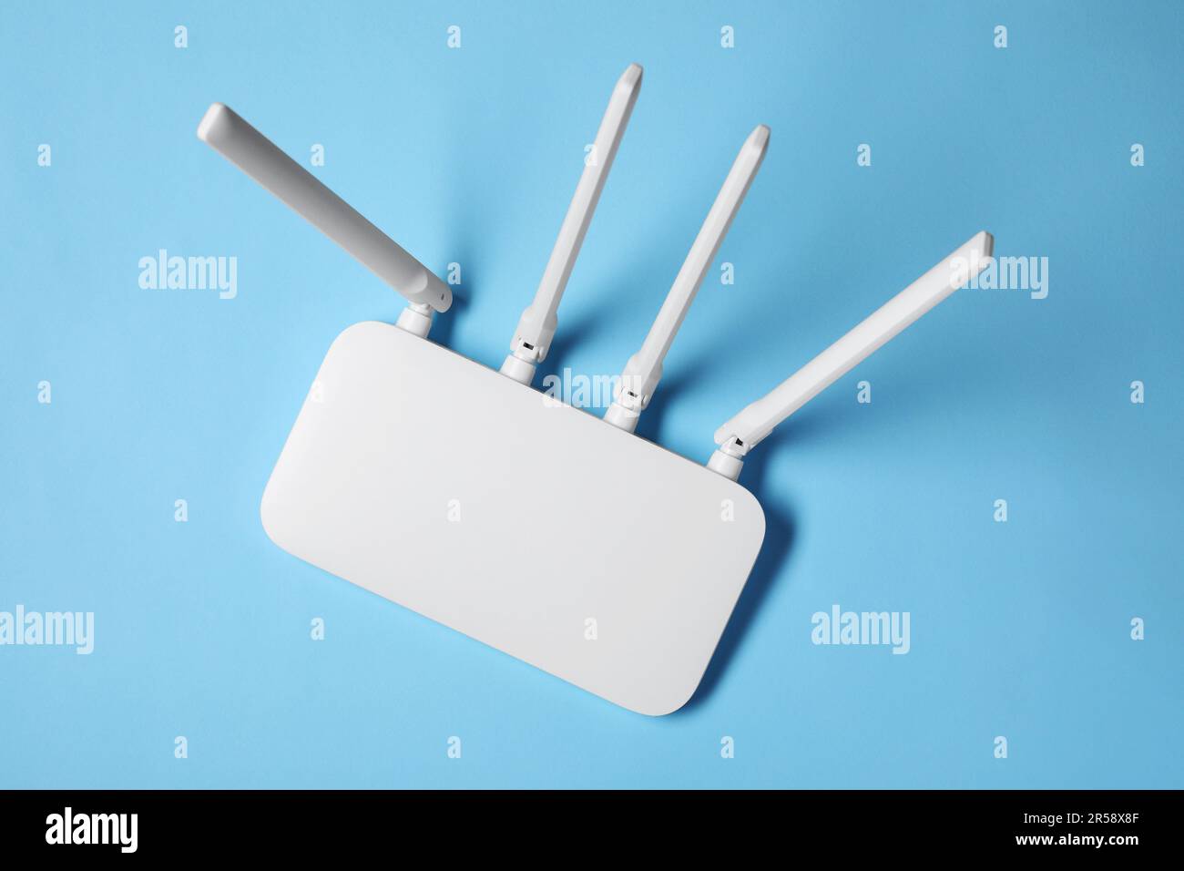 New white Wi-Fi router on light blue background, top view Stock Photo ...