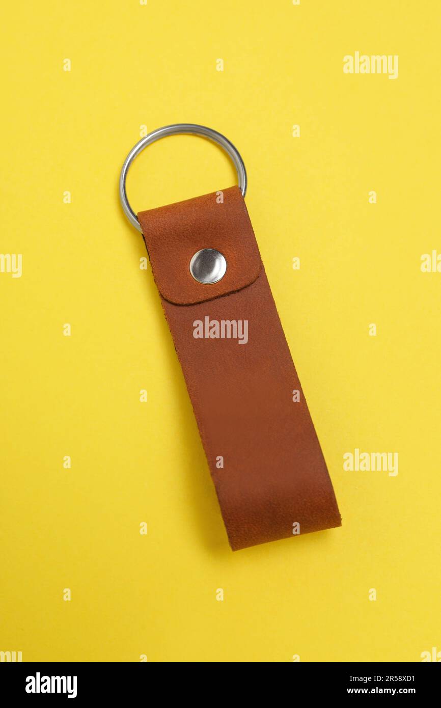 Leather keychain with Ukrainian coat of arms on yellow background, top ...