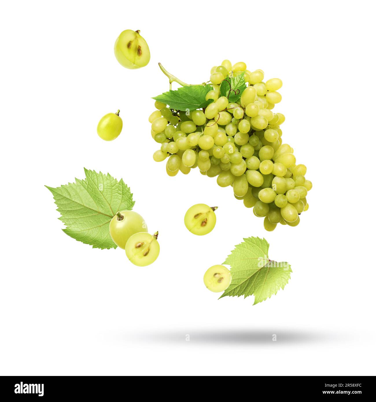 Delicious fresh grapes and leaves falling on white background Stock ...